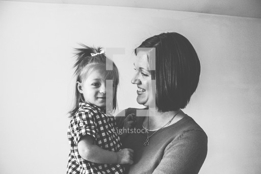 Smiling Mother Holding Her Daughter — Photo — Lightstock