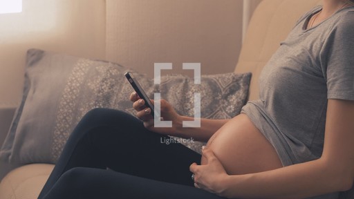 Pregnant Woman Rubbing Her Belly And Scrolling — Video — Lightstock