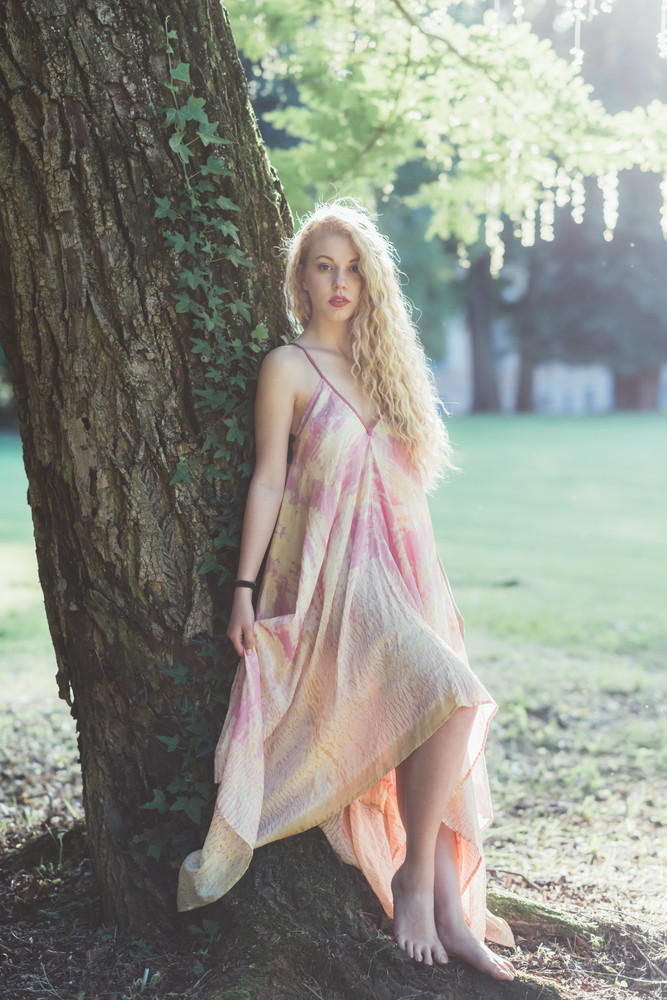 Young Beautiful Blonde Hair Woman Wearing Pink Dress Standing In The