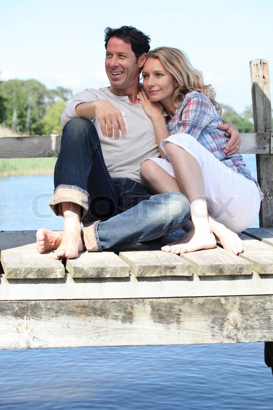 Couple Relaxing By A Lake Stock Image Colourbox