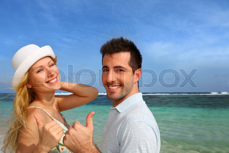 Couple At The Beach Showing Thumb Up Stock Image Colourbox