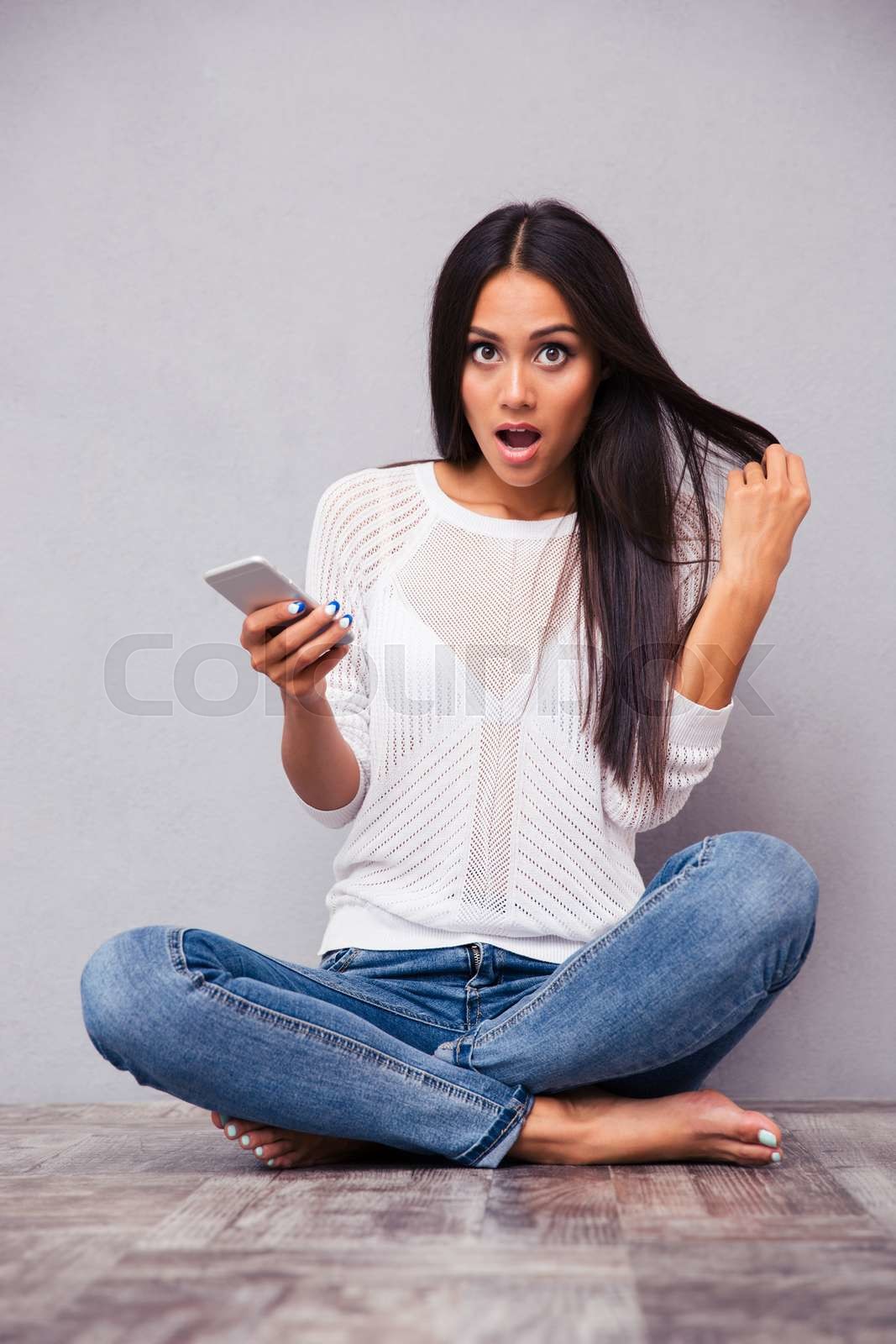 Woman Sitting On The Floor With Smartphone Stock Image Colourbox