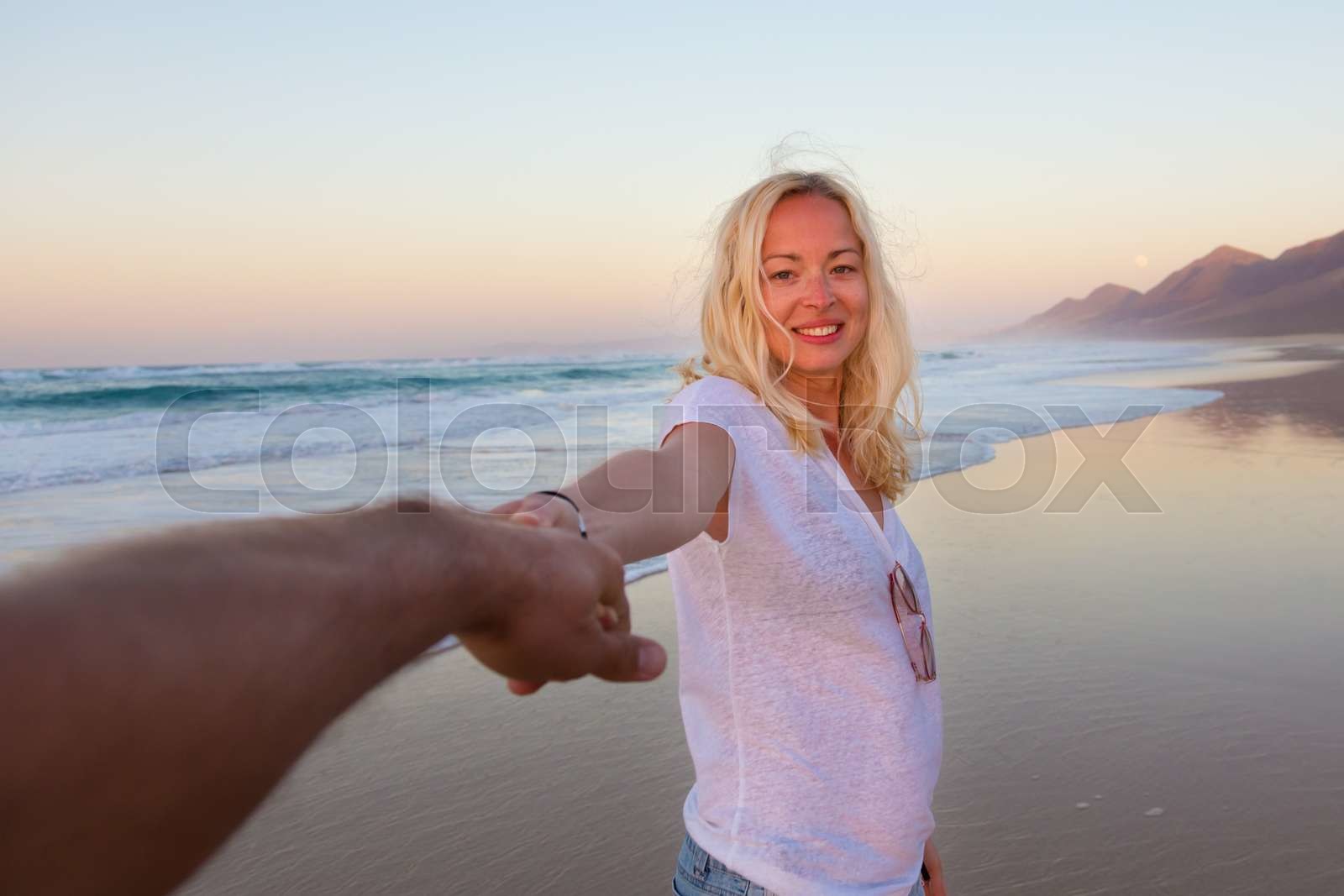 Romantic Couple Holding Hands Having Fun On Beach Stock Image