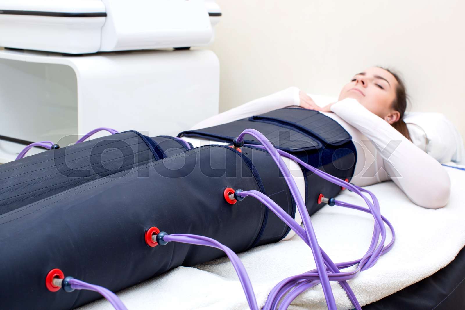 Woman At The Clinic For The Treatment Of Pressure Therapy Procedure