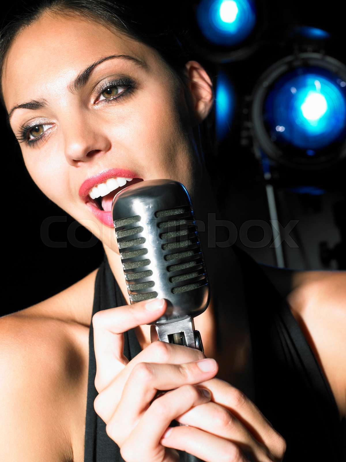 Woman Singing Into Microphone Stock Image Colourbox