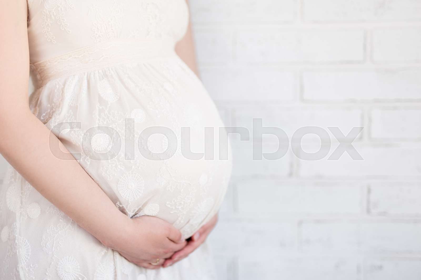 Close Up Of Pregnant Belly Over White Wall Stock Image Colourbox