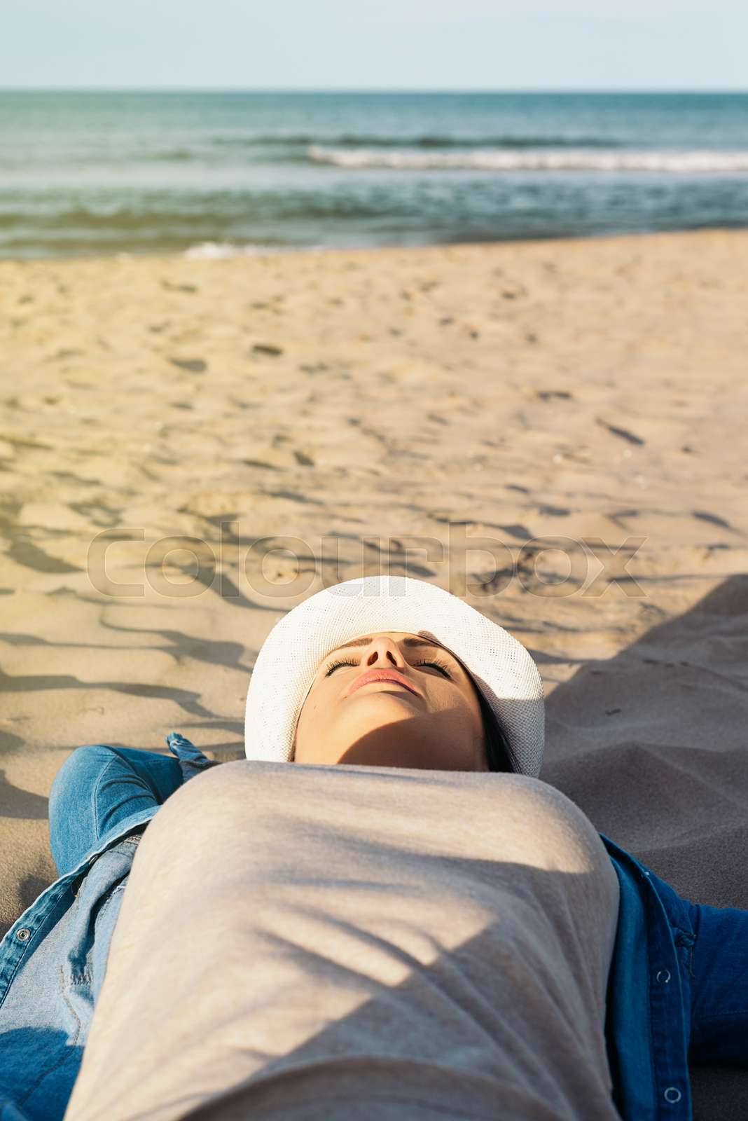 Woman Lying Relaxing On The Beach Stock Image Colourbox
