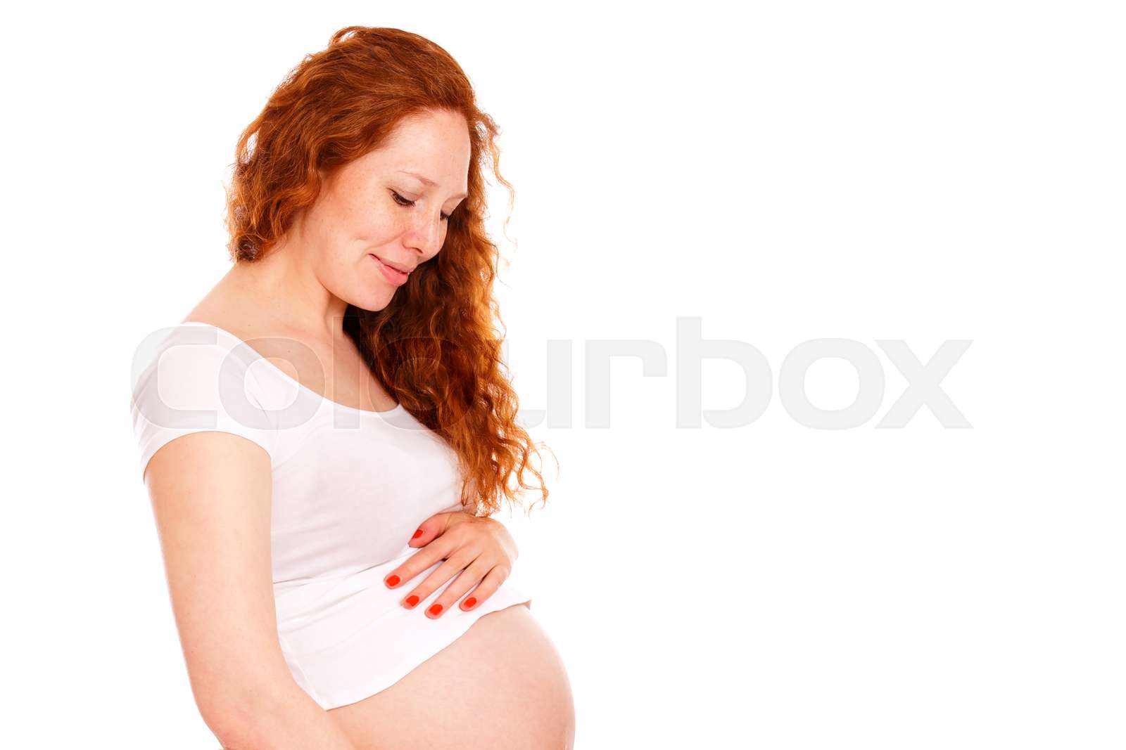 Pregnant Woman Hugging Her Belly And Smiling Stock Image Colourbox