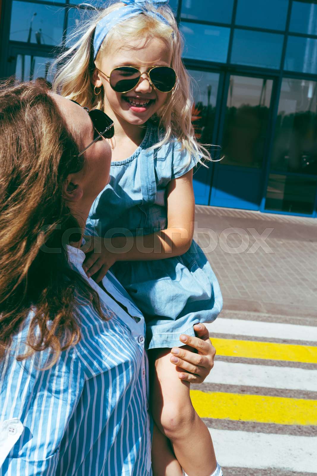 Happy Stylish Mother Holding Her Adorable Daughter On Hands Stock