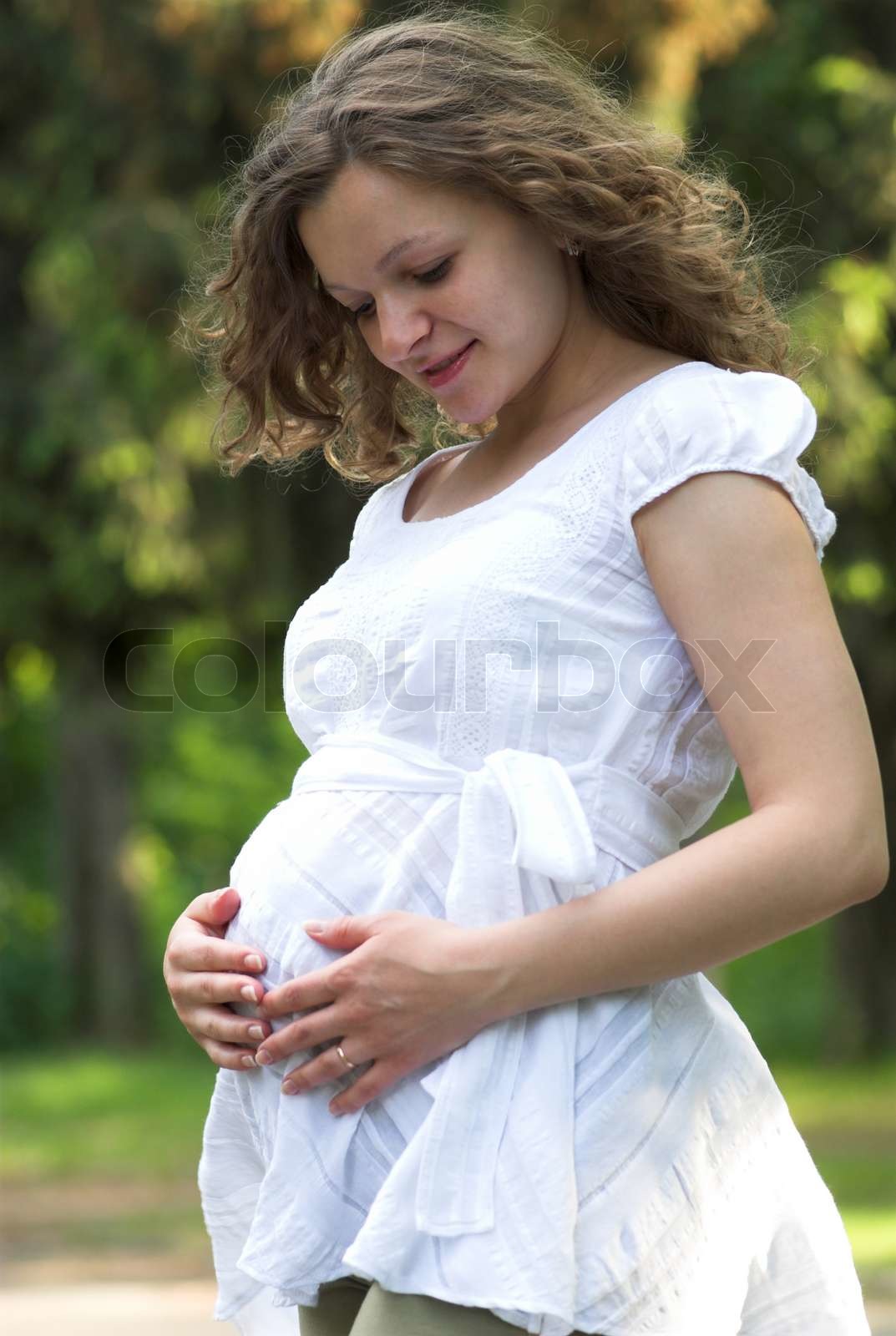 Young Pregnant Is Holding Her Belly In Park Stock Image Colourbox