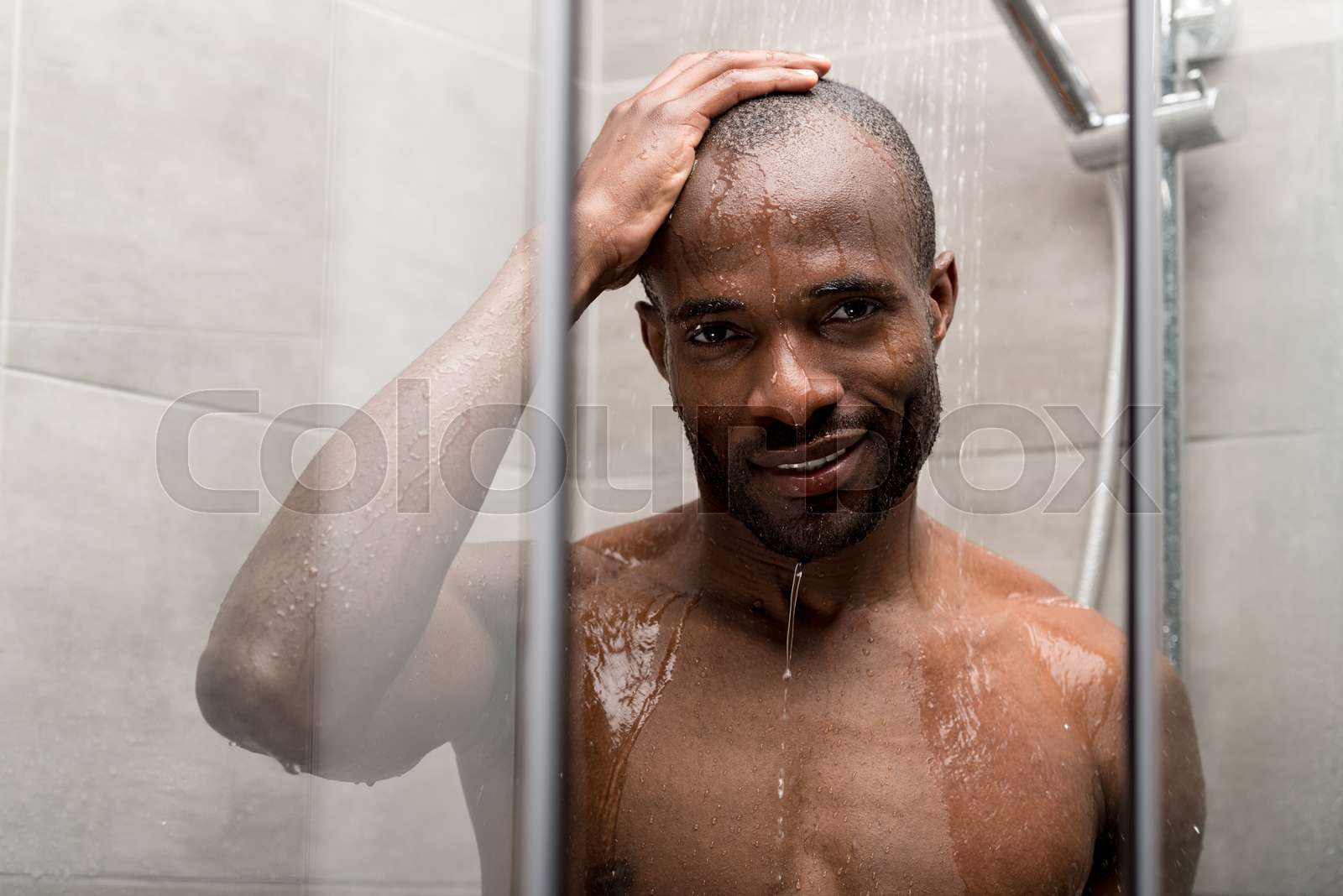 Handsome African American Man Taking Shower And Smiling At Camera