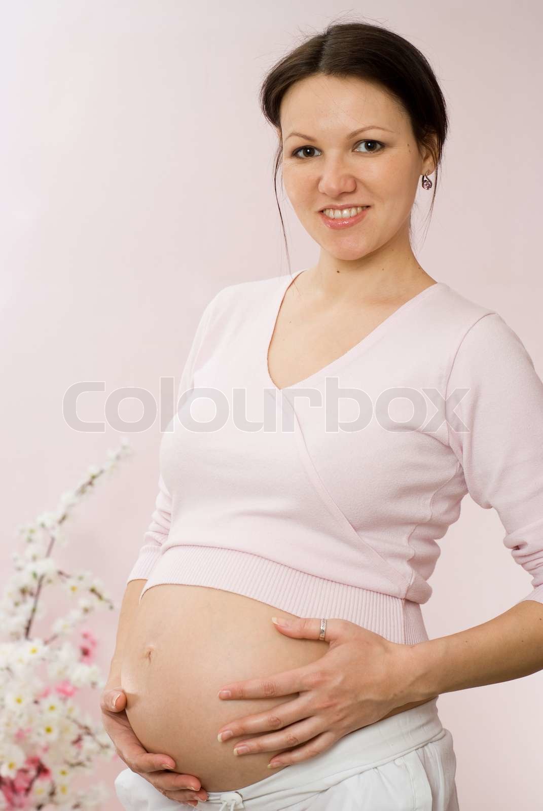 Pregnant Woman Standing Withhandshugging Her Belly Stock Image