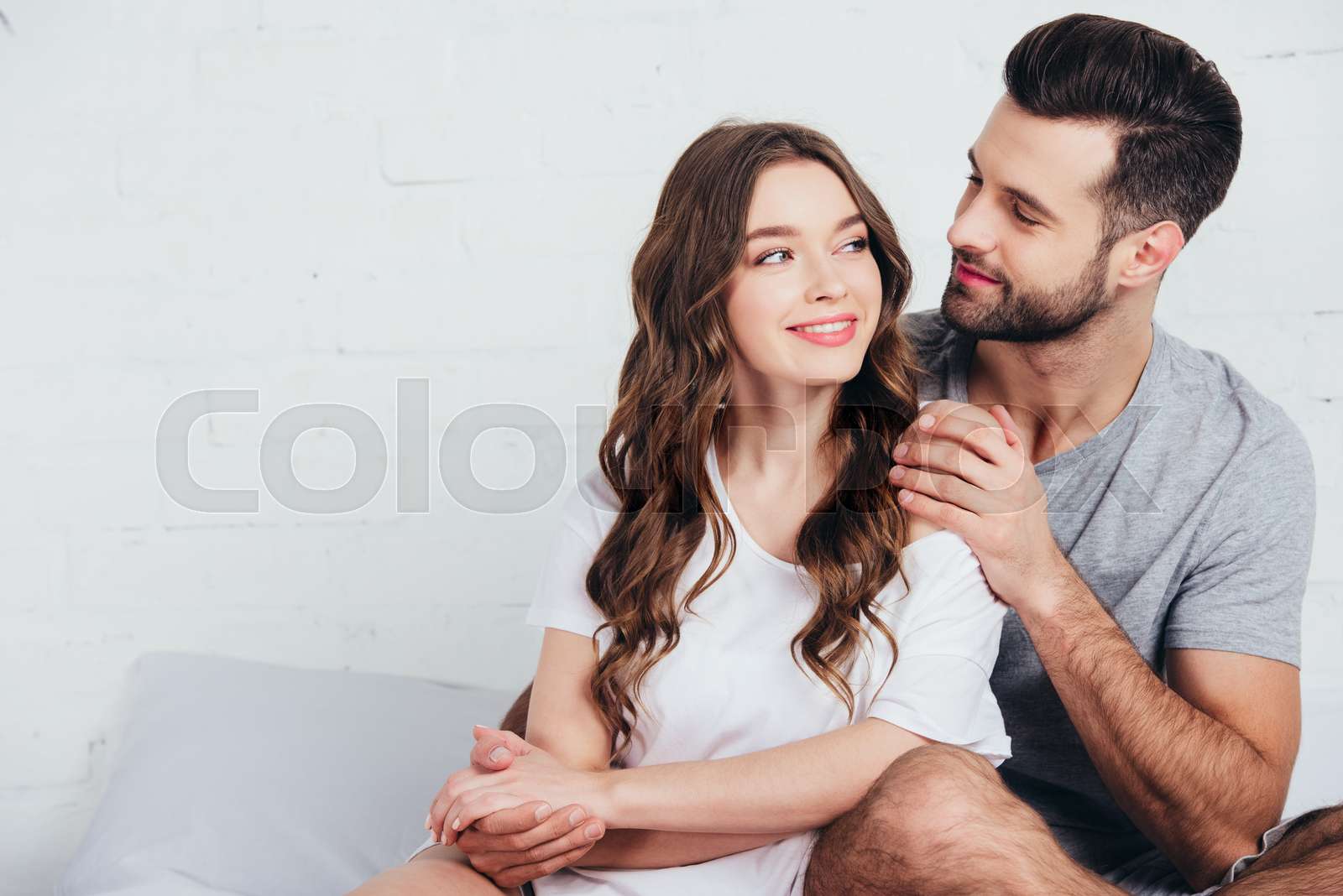 Adult Loving Couple Gentle Embracing On Bed In Bedroom Stock Image