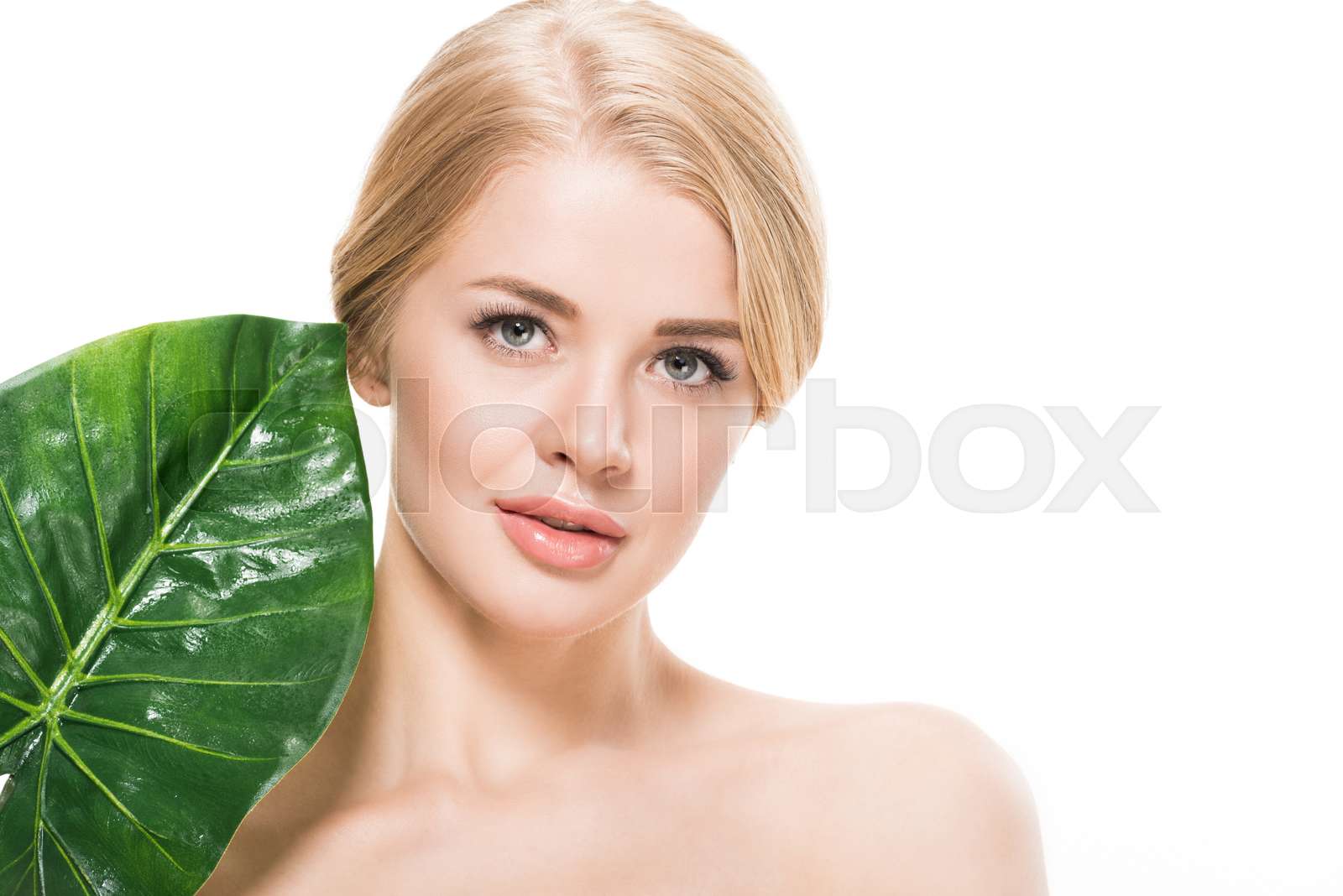 Beautiful Naked Woman Posing With Green Tropical Leaf And Looking At