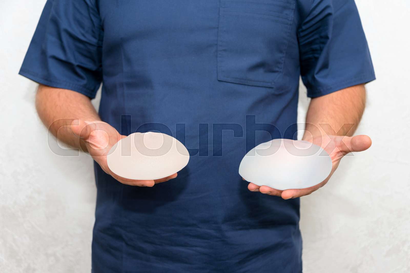 Doctor Holding Silicone Implant For Breast Augmentation Space For Text