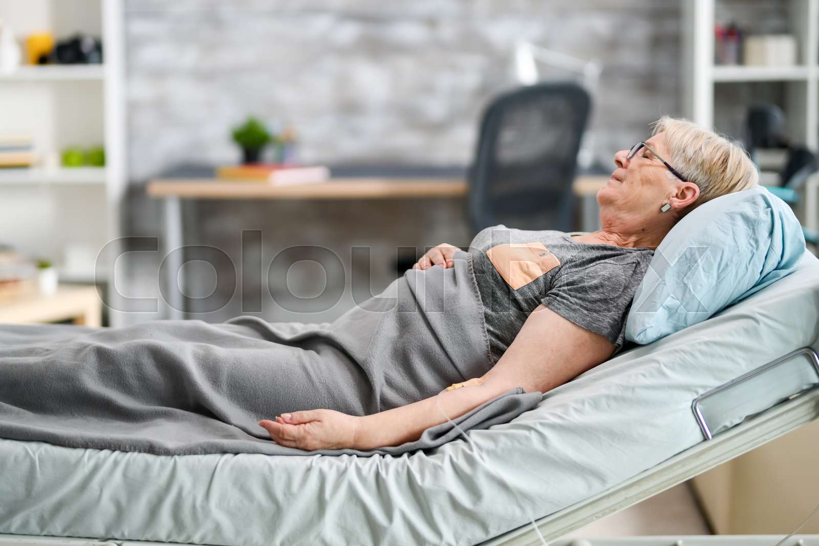 Old Granny Sleeping In A Modern Nursing Home Room Stock Image