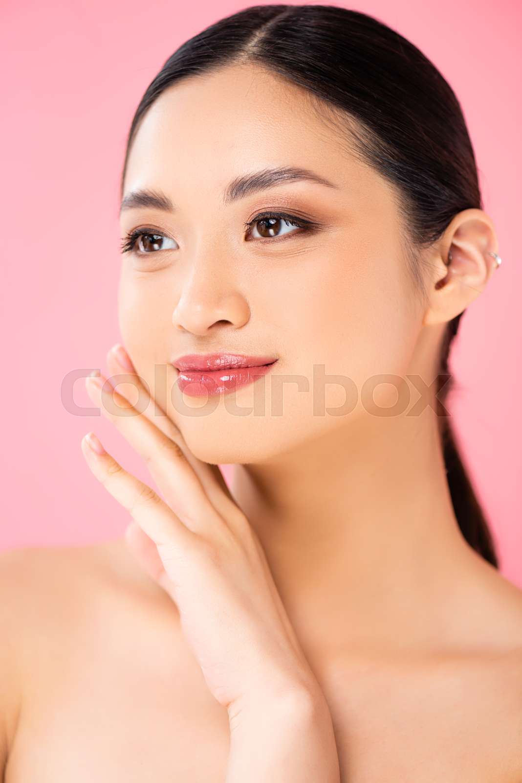 Nude Asian Woman Touching Face While Looking Away Isolated On Pink