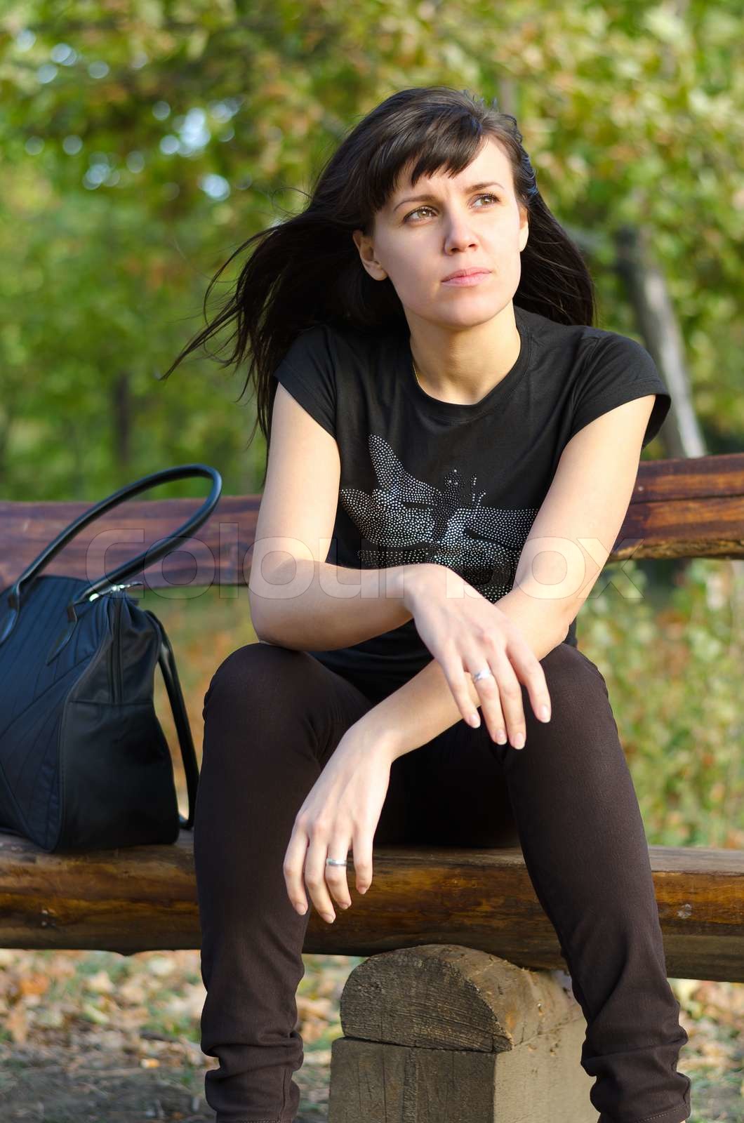 Woman Sitting Waiting On A Country Bench Stock Image Colourbox