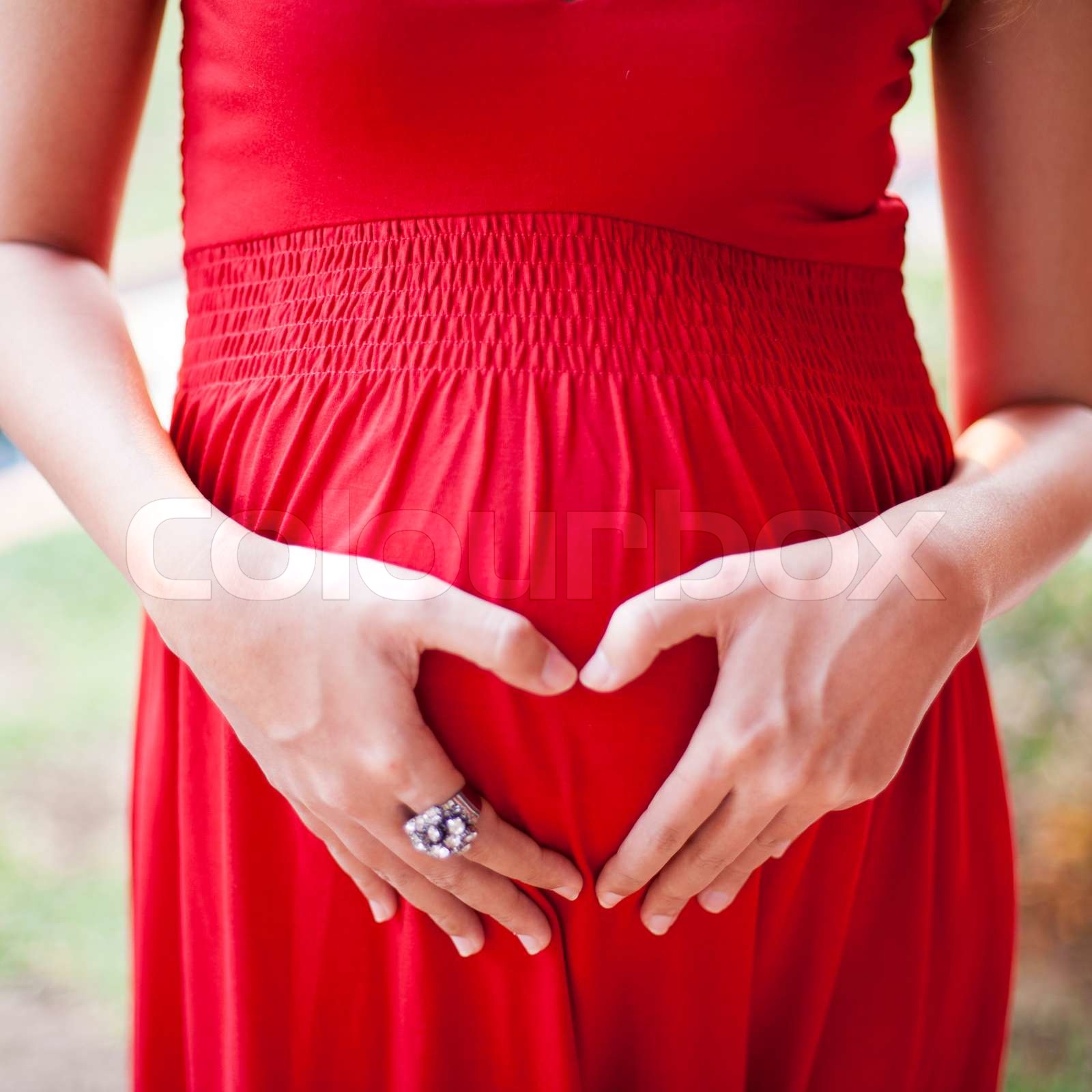 Image Of Pregnant Woman Touching Her Belly With Depicting Heart On Her