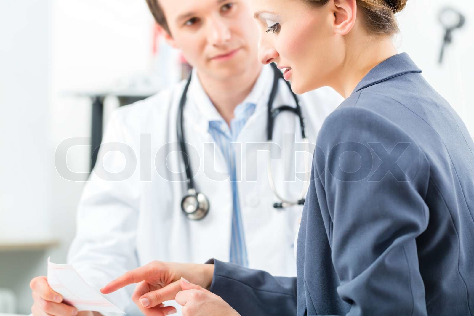 Doctor With Patient In Clinic Consulting Stock Image Colourbox