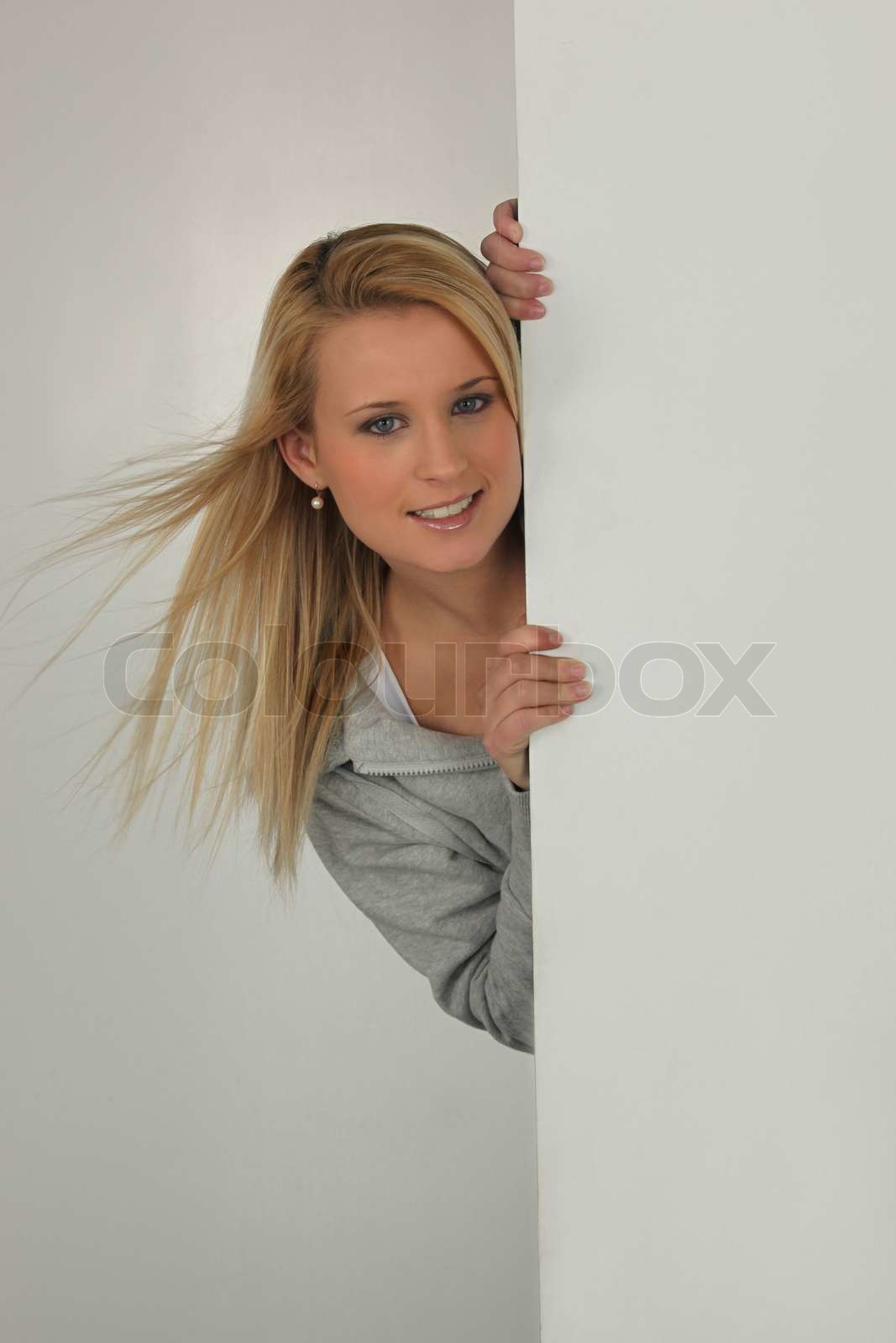 Woman Sticking Out Behind The Wall Stock Image Colourbox