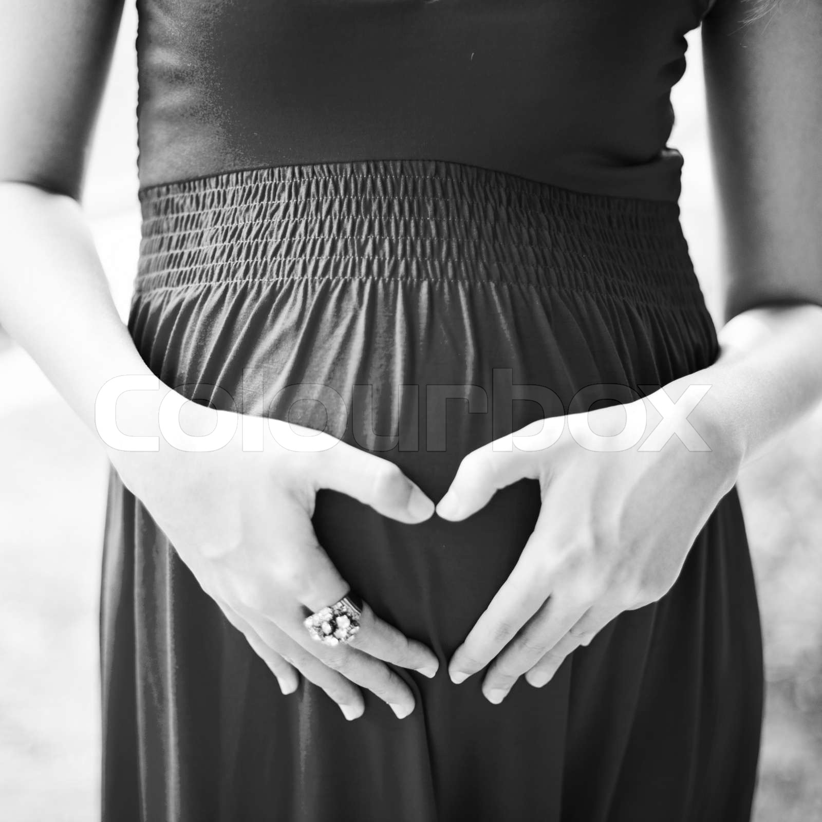 Image Of Pregnant Woman Touching Her Belly With Depicting Heart On Her