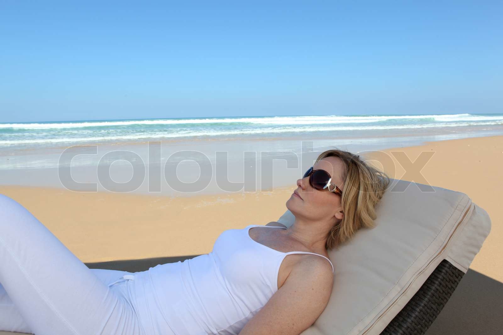 Woman Lying On A Lounger Stock Image Colourbox