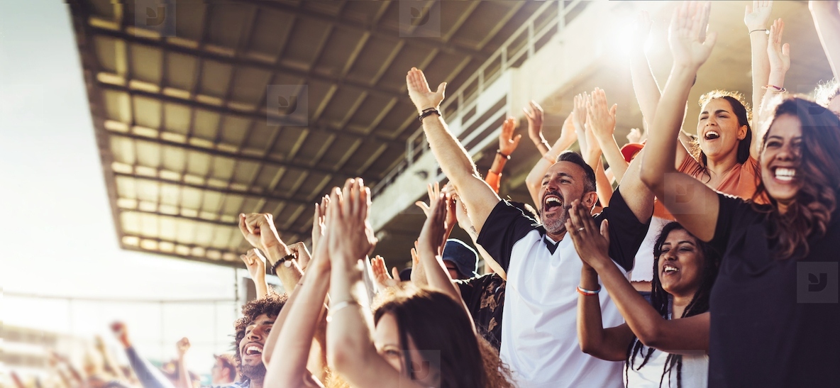 Crowd Of Sports Fans Cheering During A Match In A Stadium People