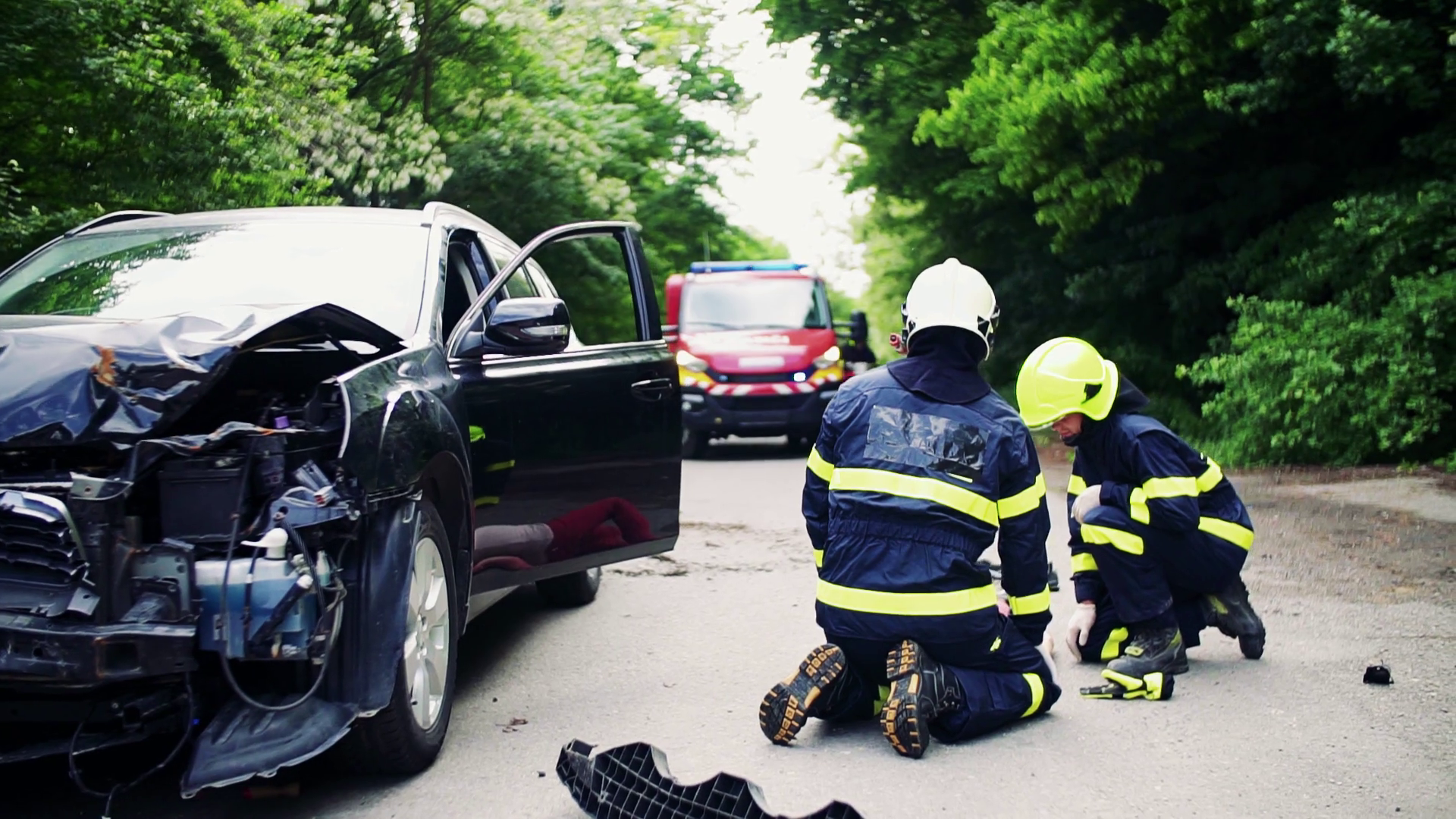 Unrecognizable Firefighters Rescuing A Young Injured Woman Lying On The