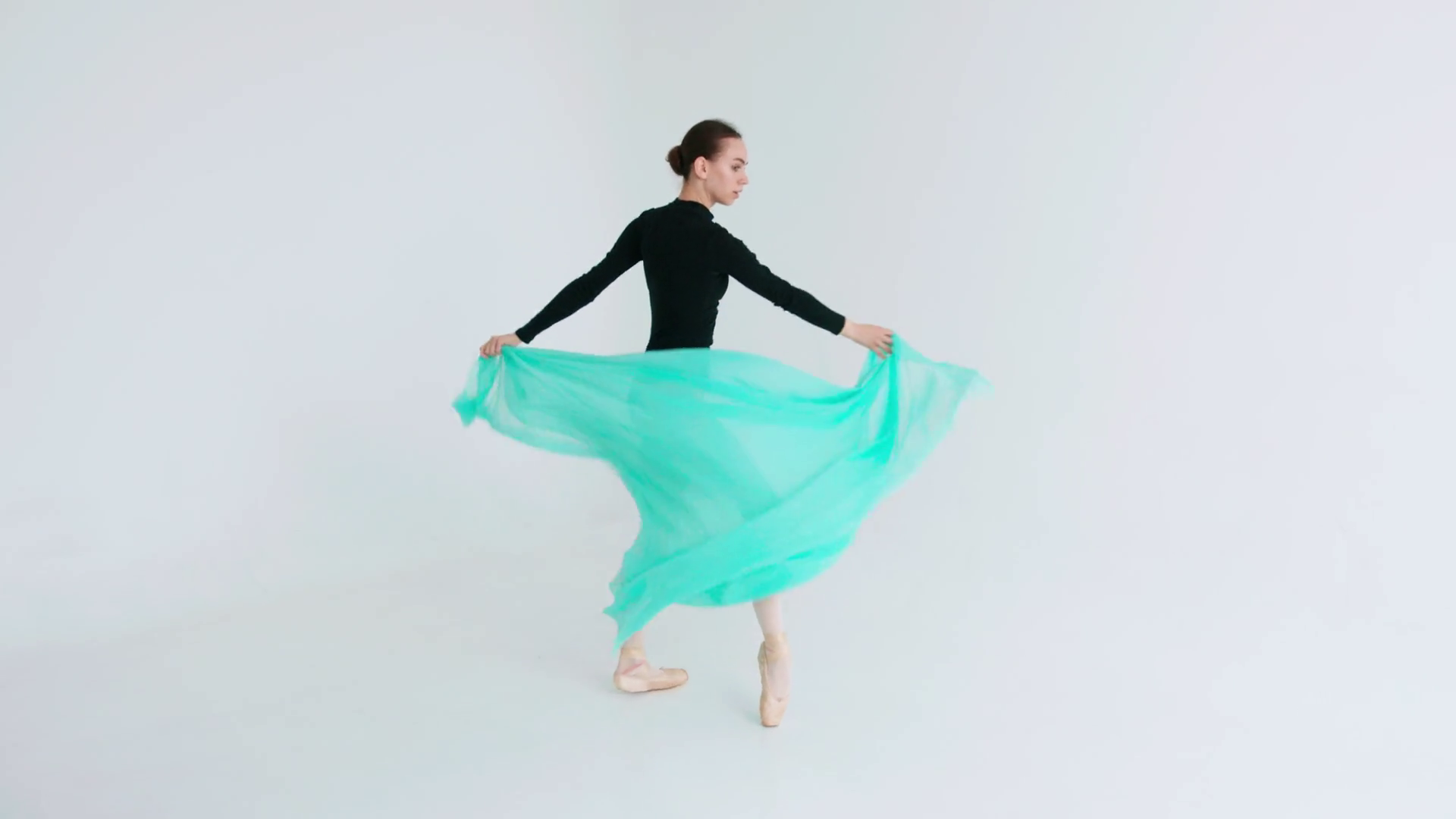 A Ballerina Dances In A White Studio And Spins On One Leg In An