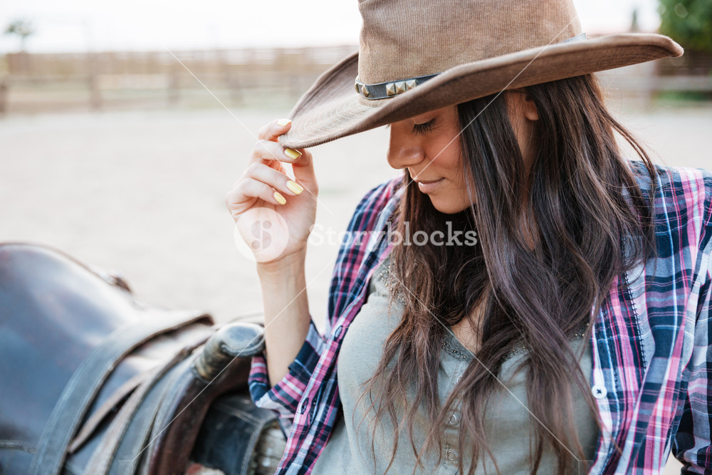 Close Up Portrait Of A Pretty Cowgirl Leaning On Fence At Ranch Royalty