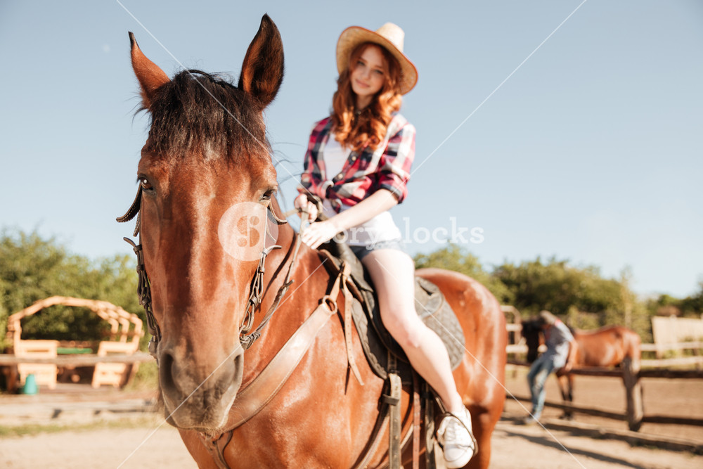 Young Redhead Cowgirl Riding Her Horse At The Ranch Royalty Free Stock