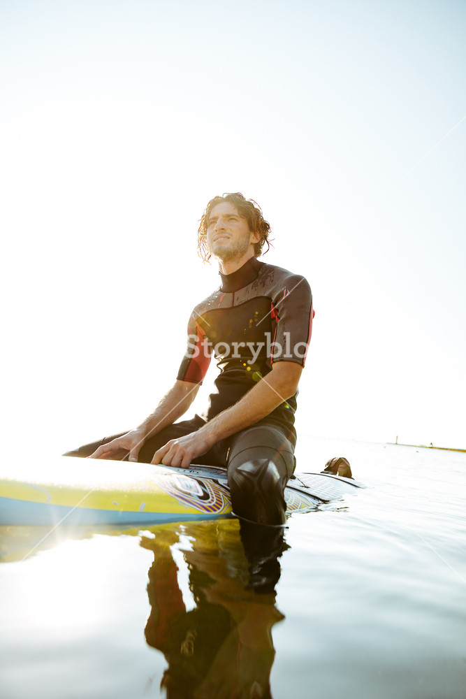 People Sitting On Surfboard