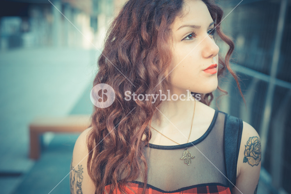 Young Beautiful Hipster Woman With Red Curly Hair In The City Royalty