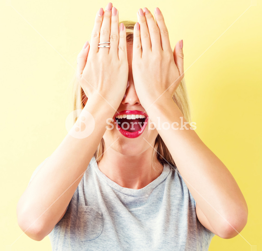 Young Woman Covering Her Eyes With Her Hands Royalty Free Stock Image