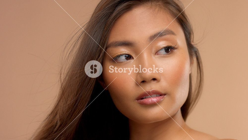 Closeup Portrait Of Asian Thai Japanese Model Wathing Aside With Hair