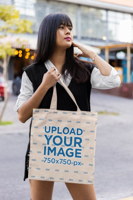 Placeit Tote Bag Mockup Featuring A Woman Posing On The Street