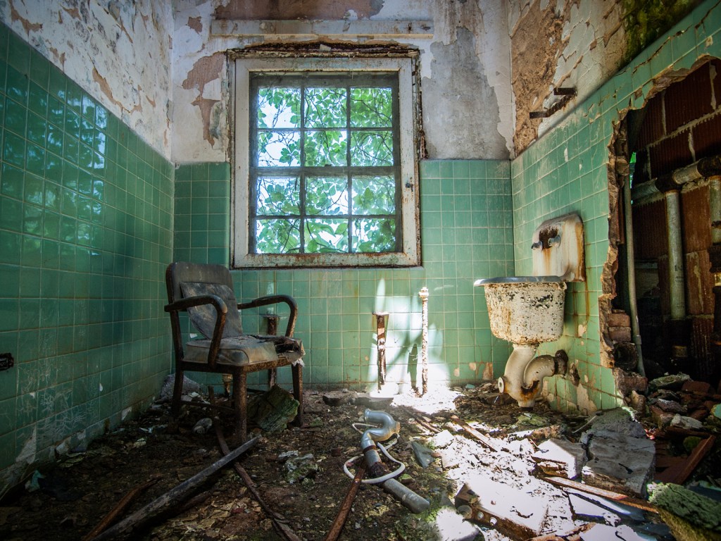 A Dark And Deserted Asylum Sits Quietly Falling To Pieces