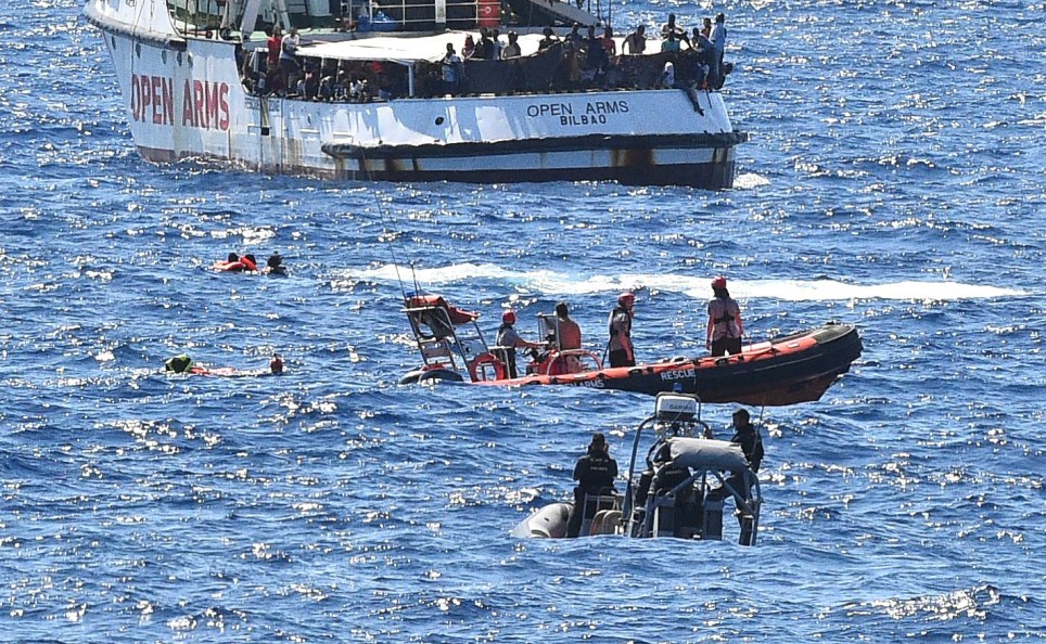 Desperate Migrants Jump Into Water To Italian Island From Stand Off