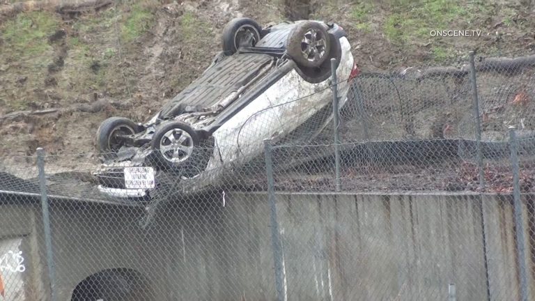 Vehicle Slides Down Embankment Gets Wrapped In Power Lines After Crash