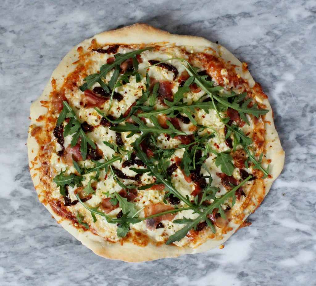 Three Cheese Pizza With Prosciutto Sun Dried Tomatoes And Arugula