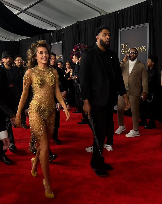 Moment Miley Cyrus Walks The Red Carpet Into The Grammys With Her